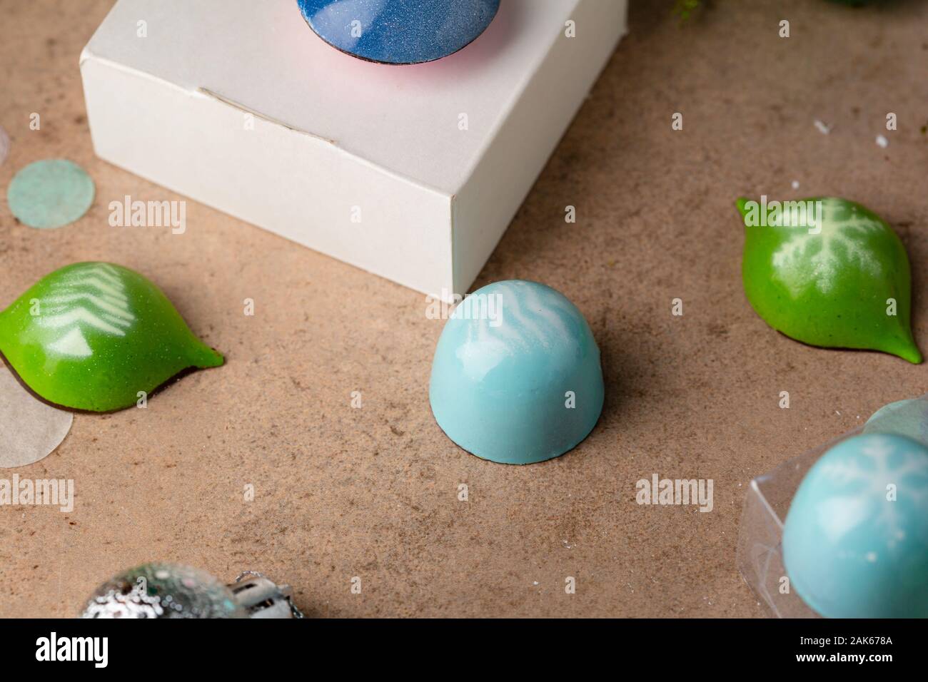 Handmade chocolate candy close-up, blue and green Stock Photo - Alamy