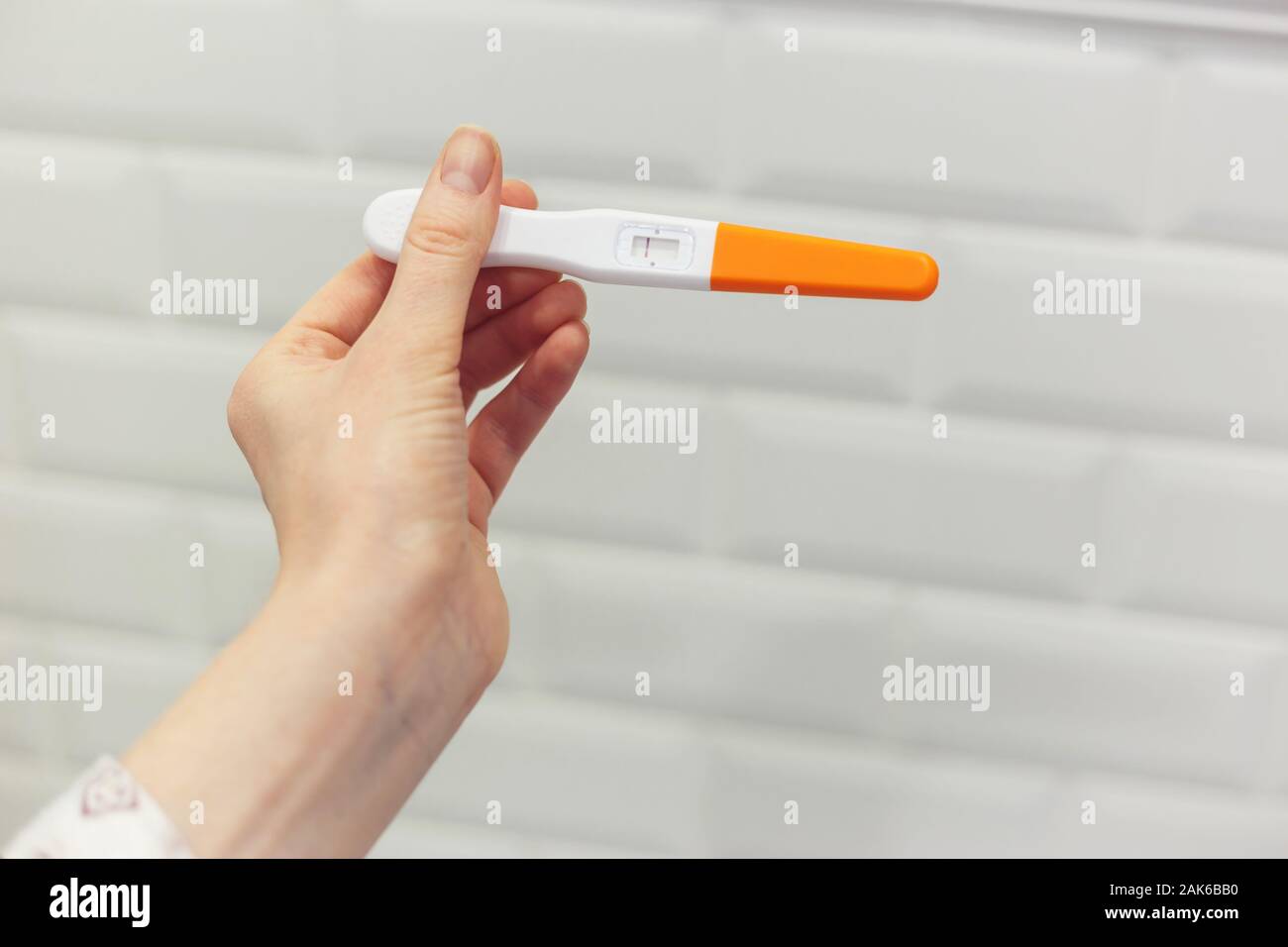Rapid pregnancy test with negative result in woman's hand. Human ...
