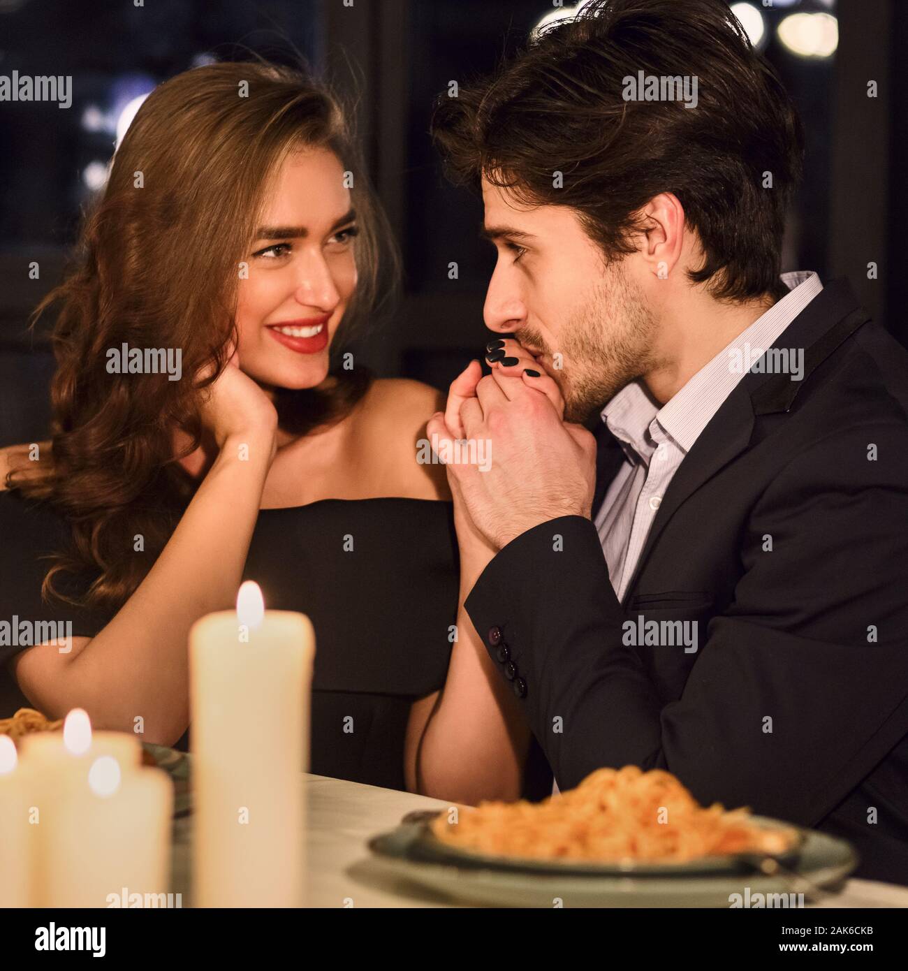 Man kissing hand girlfriend restaurant hi-res stock photography and ...