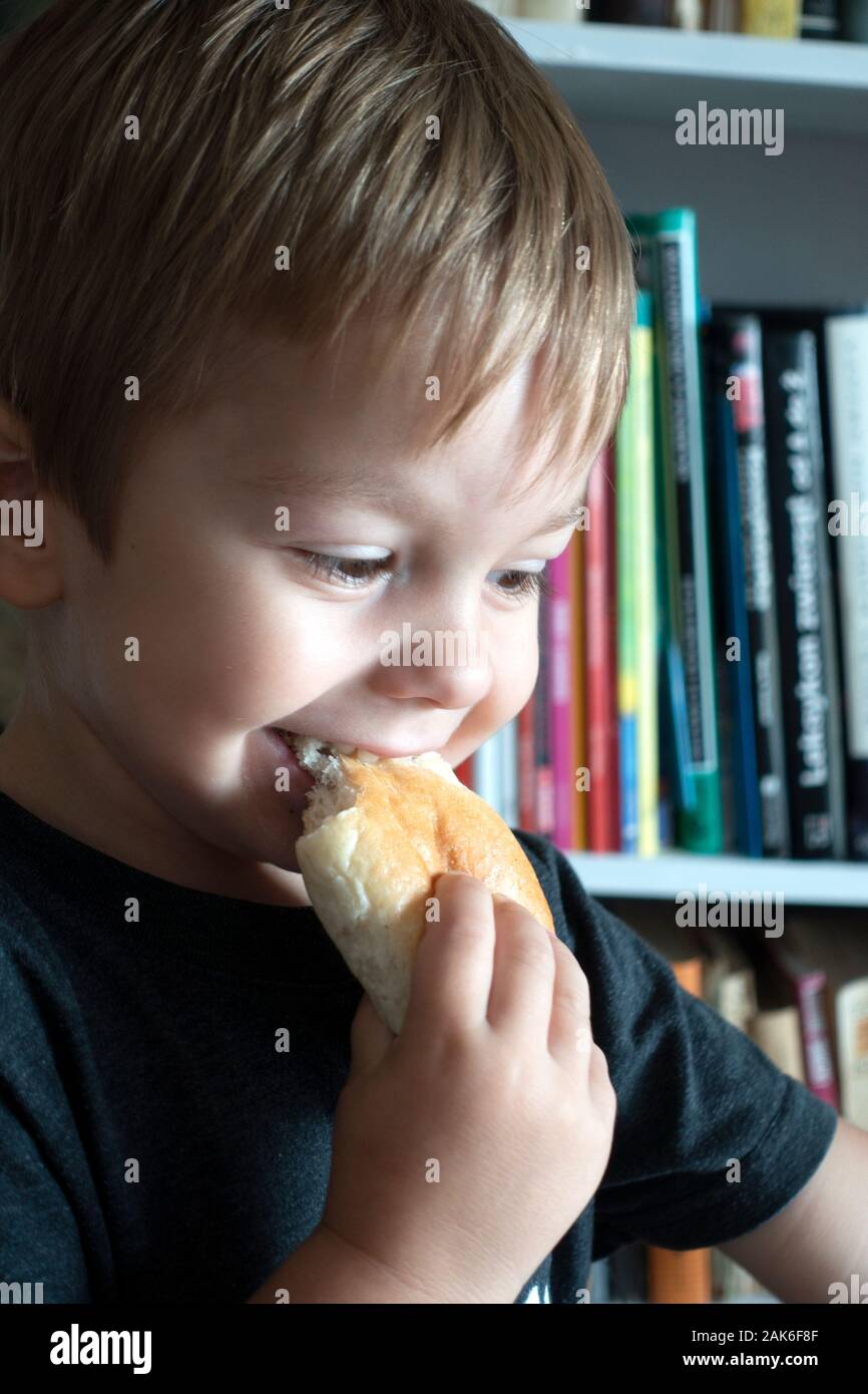 Child eating bread white hi-res stock photography and images - Alamy