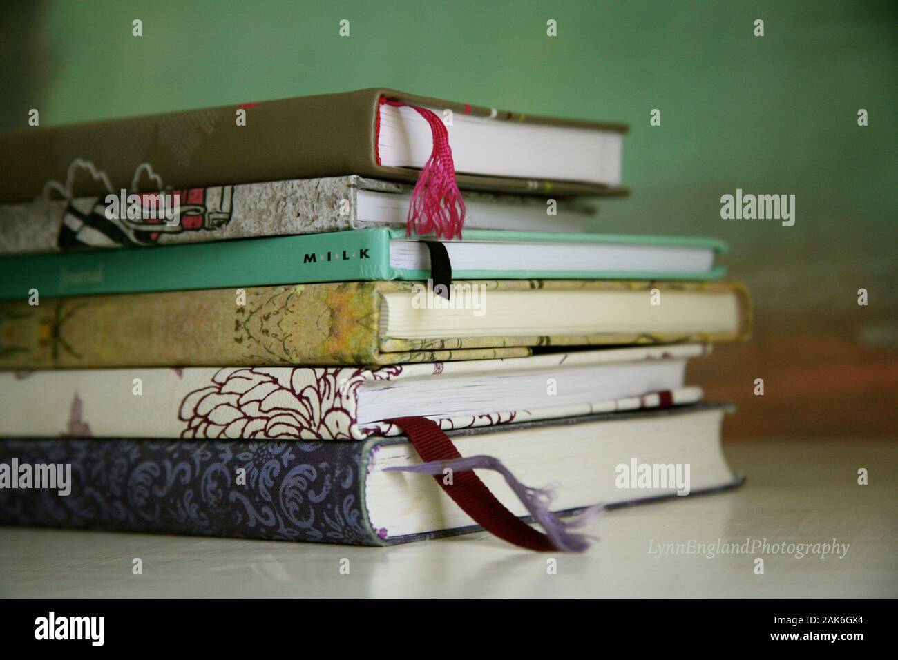 Stack of coloured writing journals with bookmarks on the shelf Stock ...