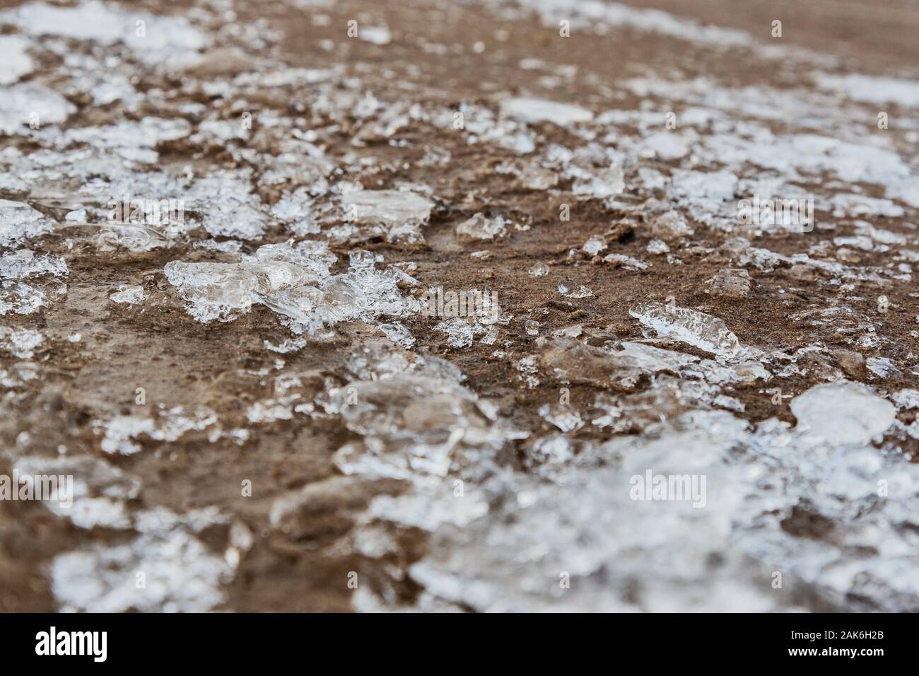 Pieces of broken ice on a sand surface Stock Photo - Alamy