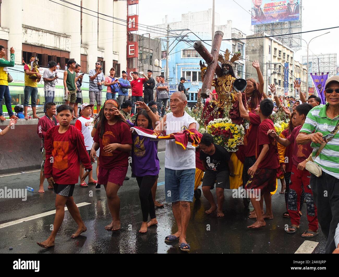 An old man with his family carry their Nazarene replica during the ...