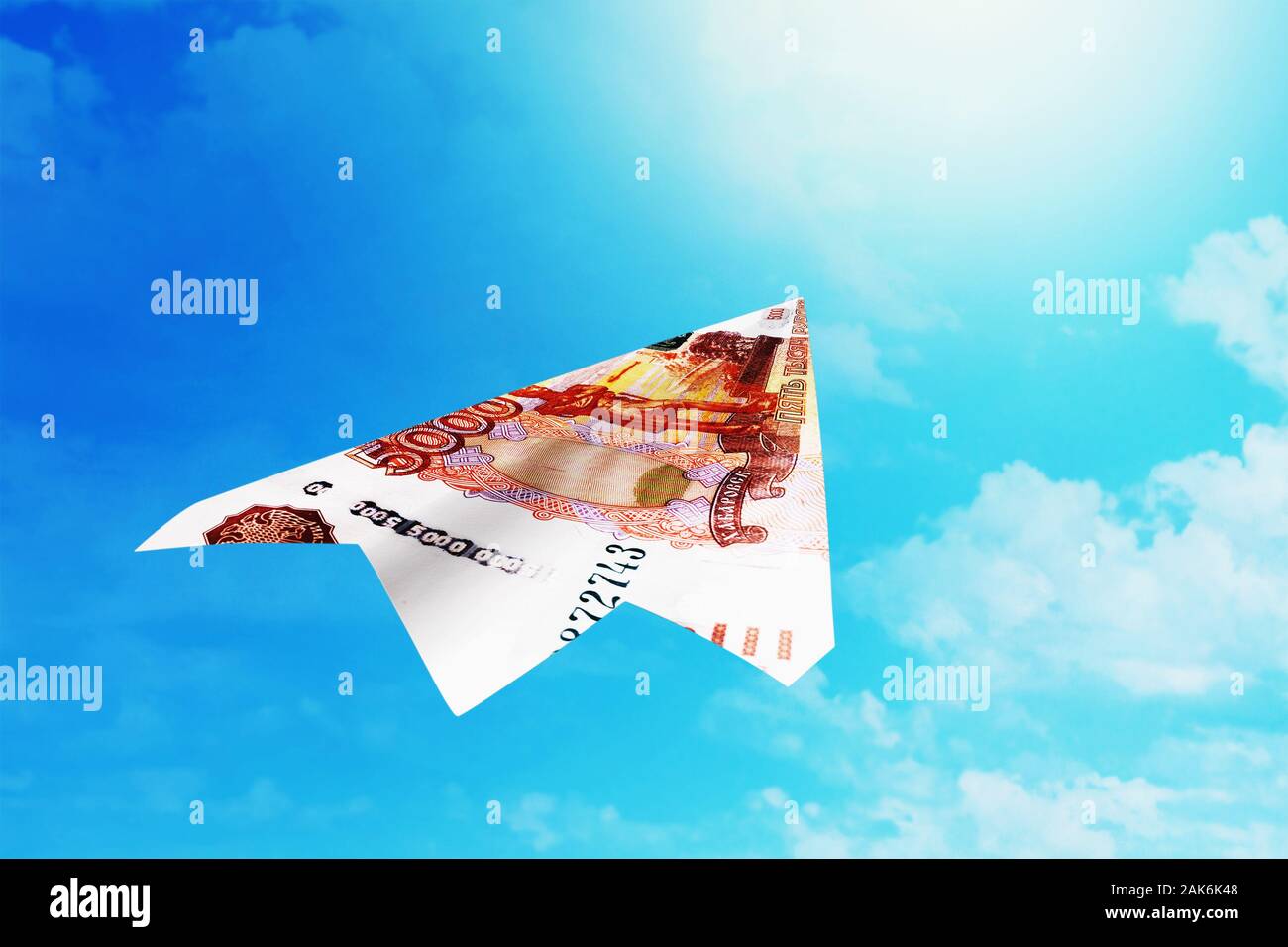 Paper airplane made of russian money on sky background. Concept on the ...