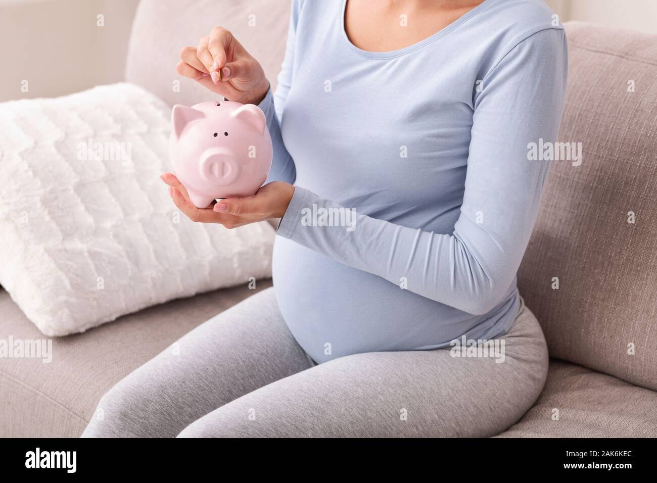 Pregnancy And Budget. Unrecognizable Pregnant Lady Putting Coin In ...