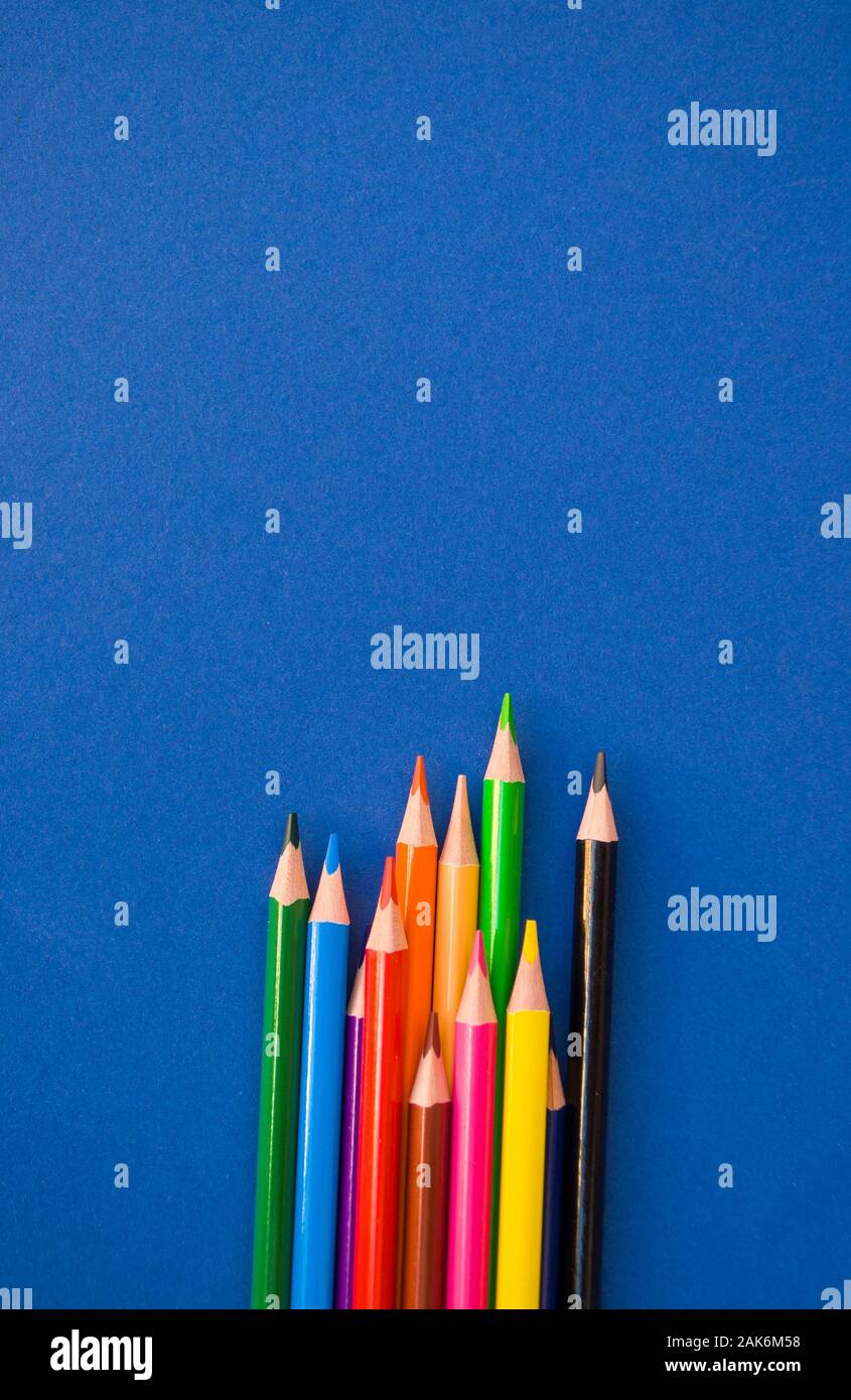 Colorful pencils on blue background with copyspace. 2020 color trend ...