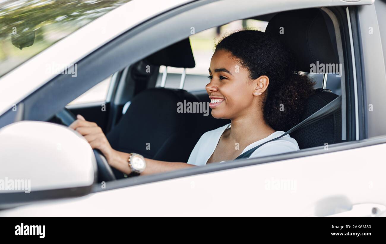 Portrait of happy young woman driving a car Stock Photo - Alamy