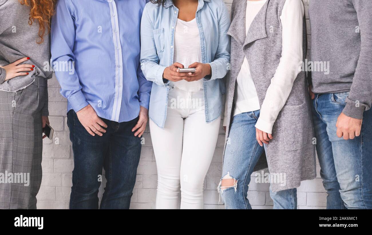 Modern people. Group of millennials watching one cellphone, panorama ...