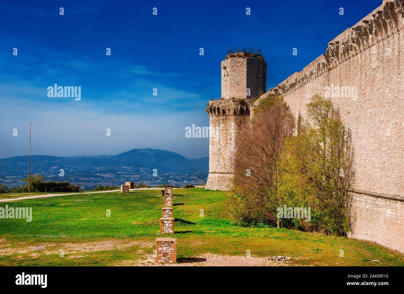 Assisi ancient medieval walls ruins at the top of the town with Umbria ...
