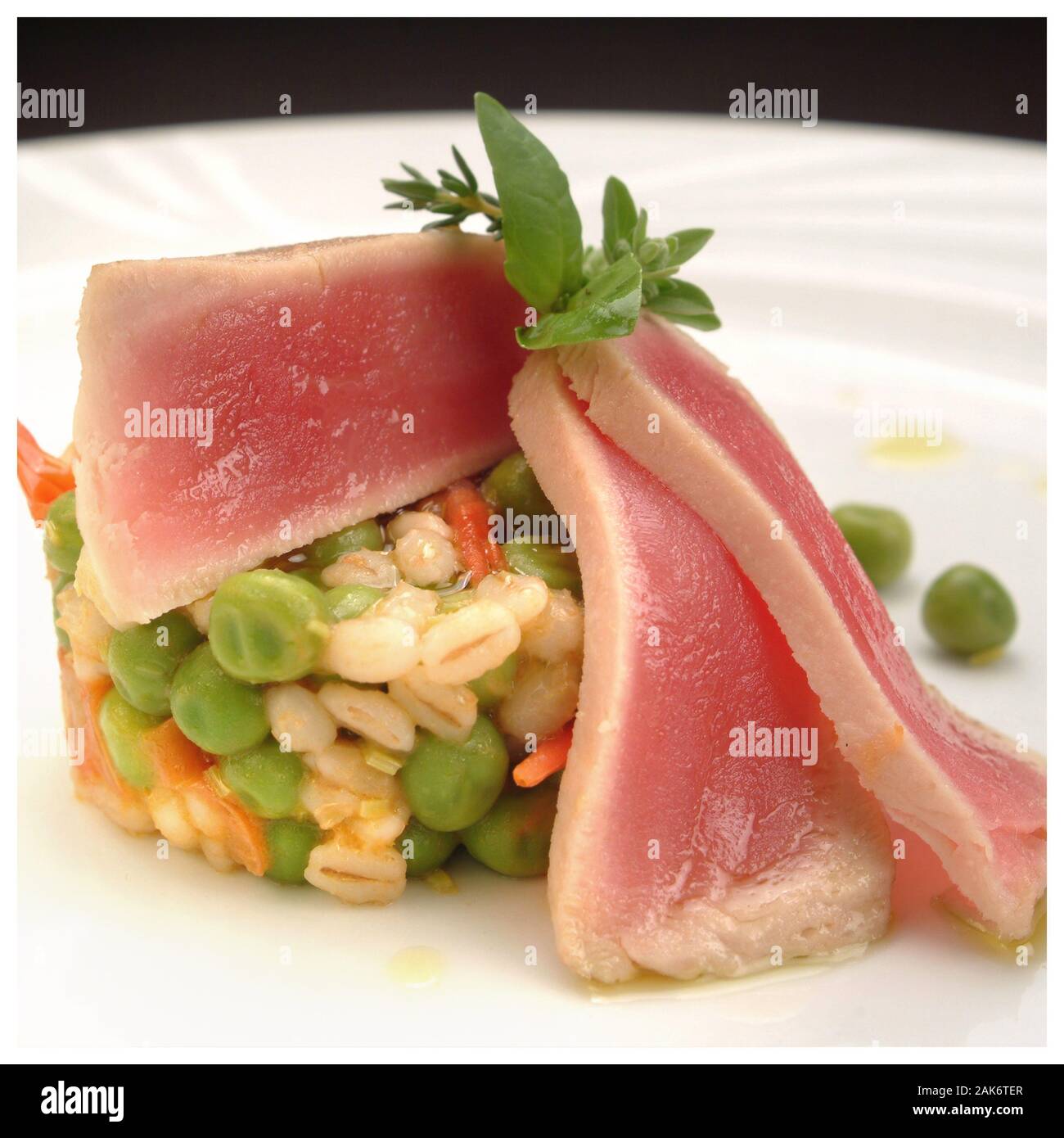 Italian food recipes, Tuna belly with barley and peas Stock Photo - Alamy
