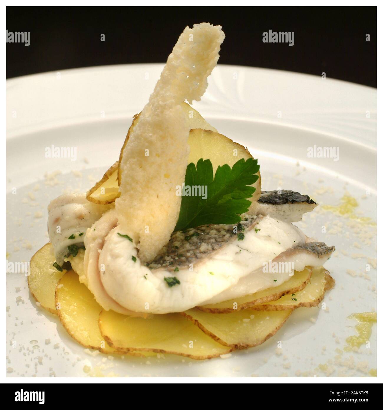 Italian food recipes sea bream with potatoes slices Stock Photo - Alamy