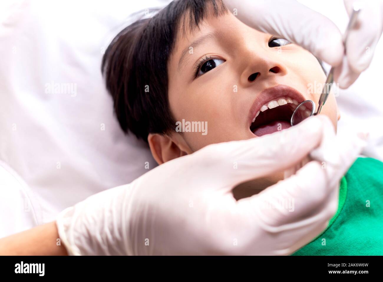 The dentist examining little boy teeth in dental clinic. copy space for ...
