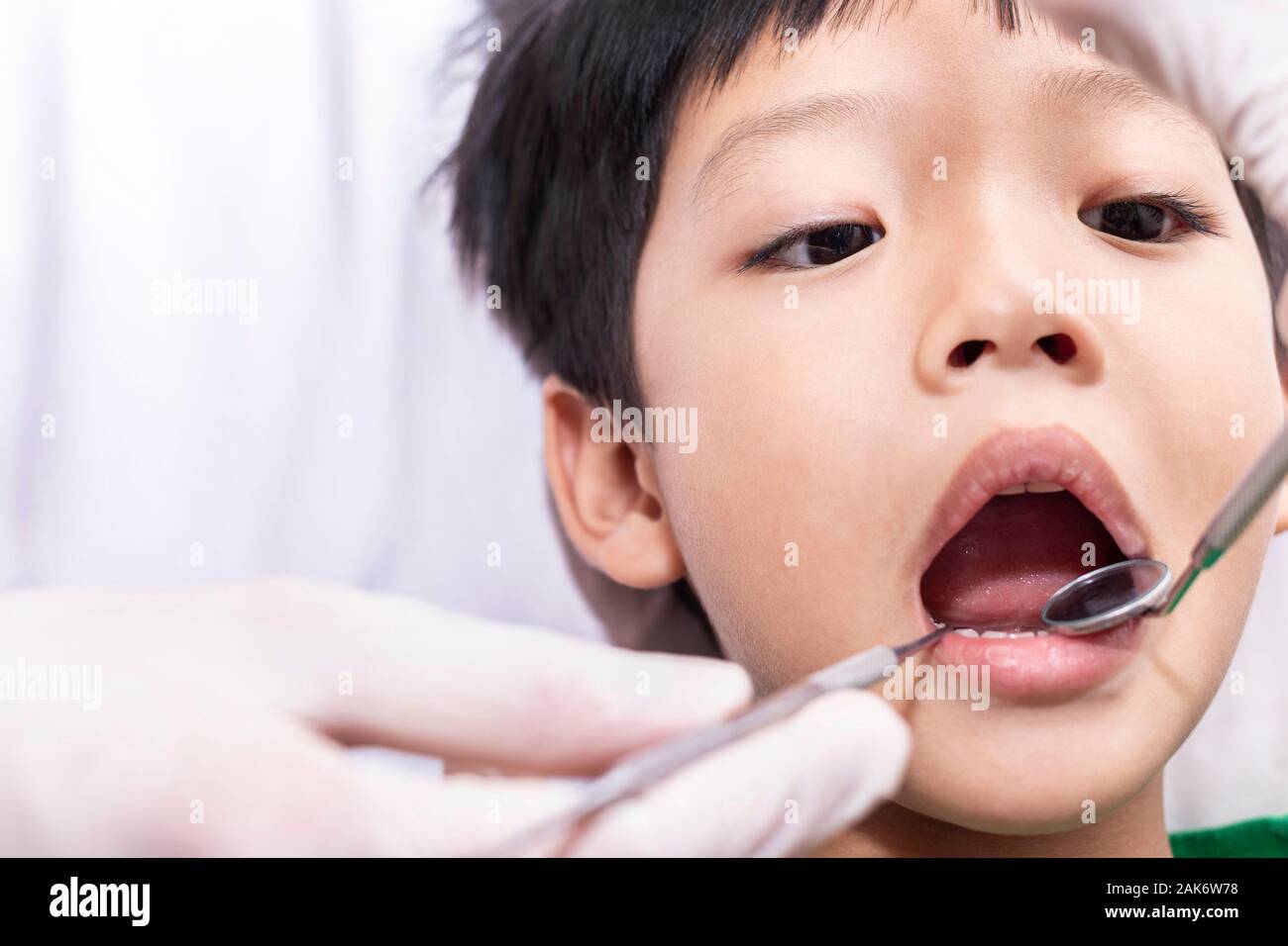 The dentist examining little boy teeth in dental clinic. copy space for ...