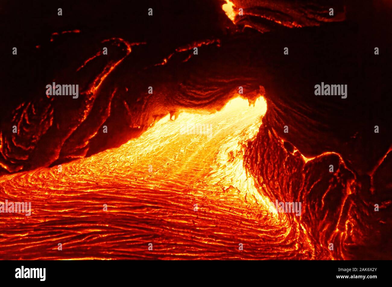 Detailed view of an active lava flow hot magma emerges from a crack in the earth the glowing lava appears in strong yellows and reds Location Haw Stock Photo Alamy