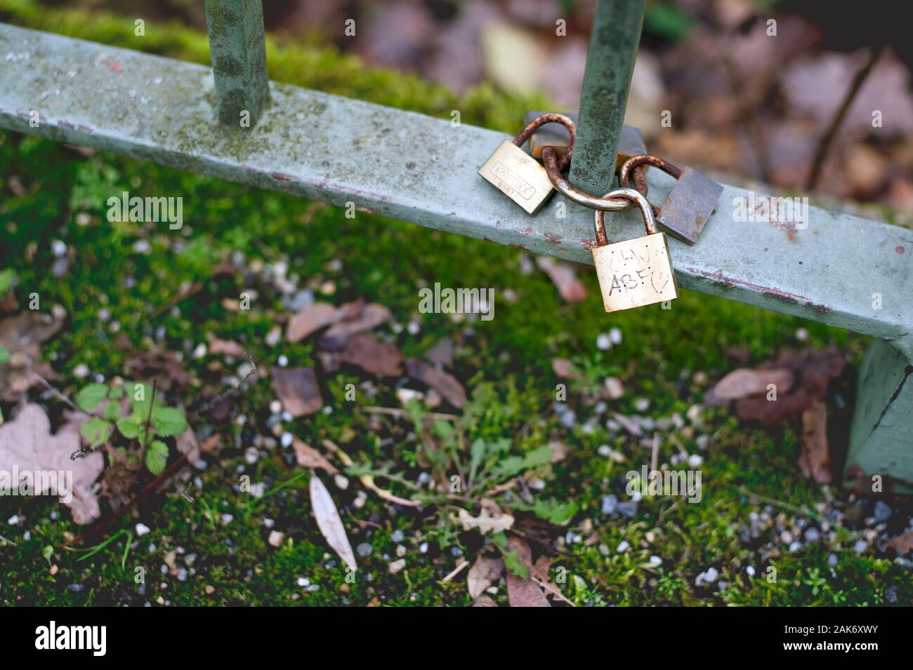 Two golden locks on the bridge as a symbol of love Stock Photo - Alamy