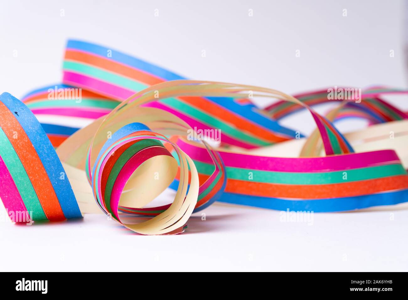 A paper streamer laying on white background - close up Stock Photo - Alamy