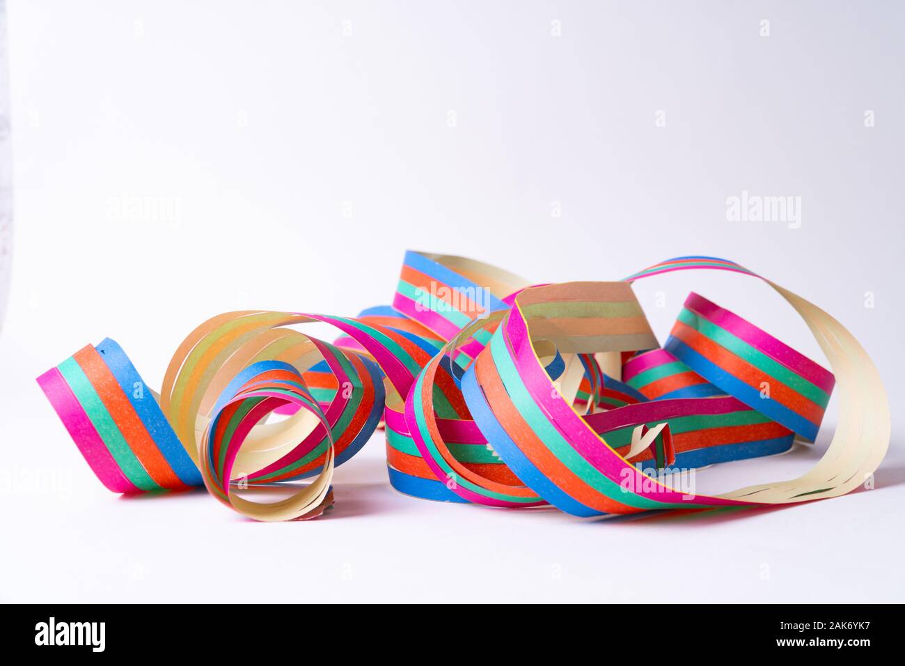 A paper streamer laying on white background - close up Stock Photo - Alamy