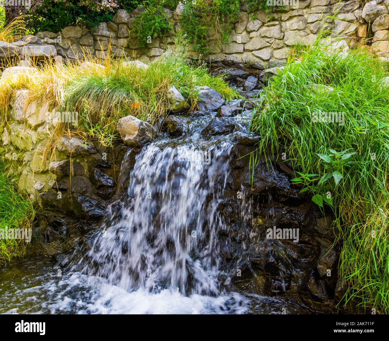 beautiful garden architecture, small waterfall streaming over rocks ...