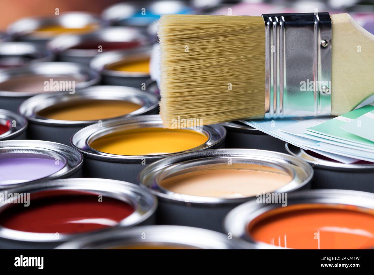 Metal tin cans with color paint and paintbrush Stock Photo - Alamy