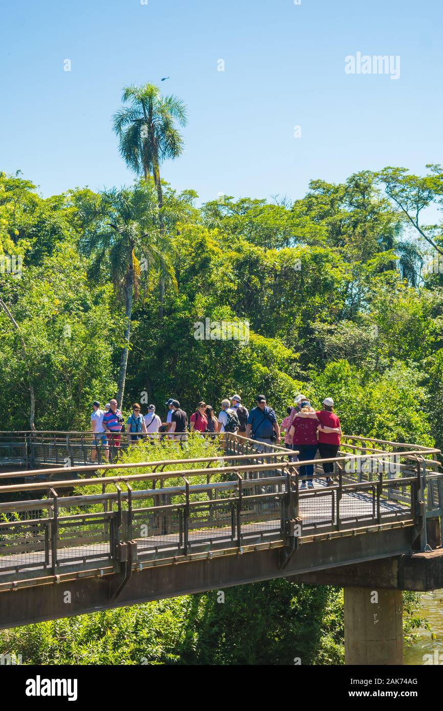 Tourists walking on the suspended walkway leading to the Devil's Throat ...
