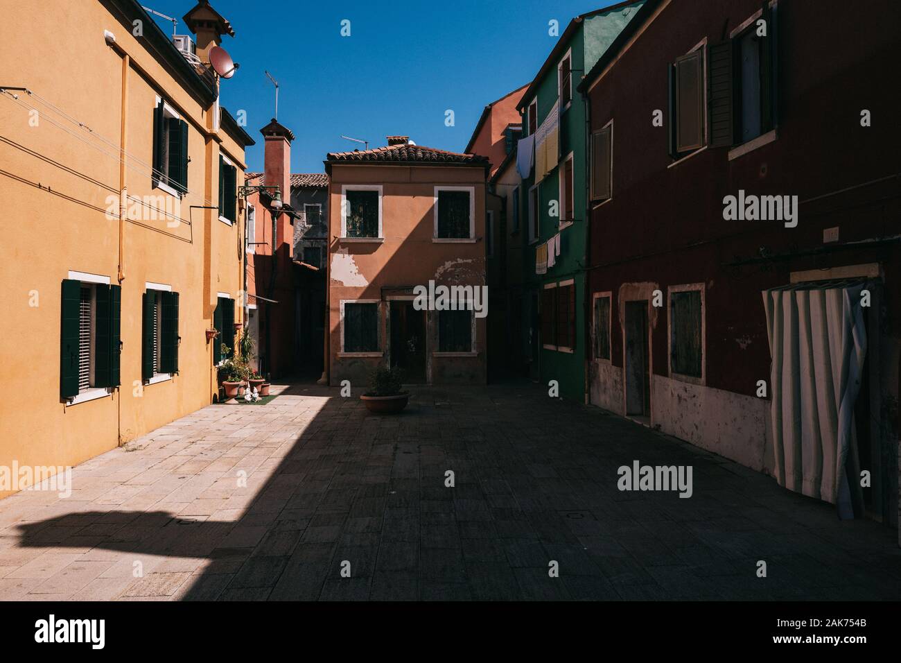 small italian square with colorful houses of Murano Stock Photo - Alamy