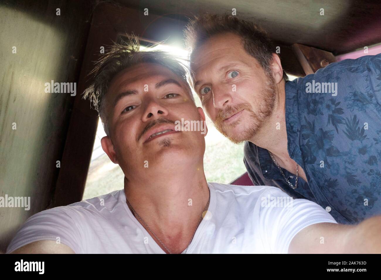 Happy friends taking a selfie in a little house. Two friends having fun ...