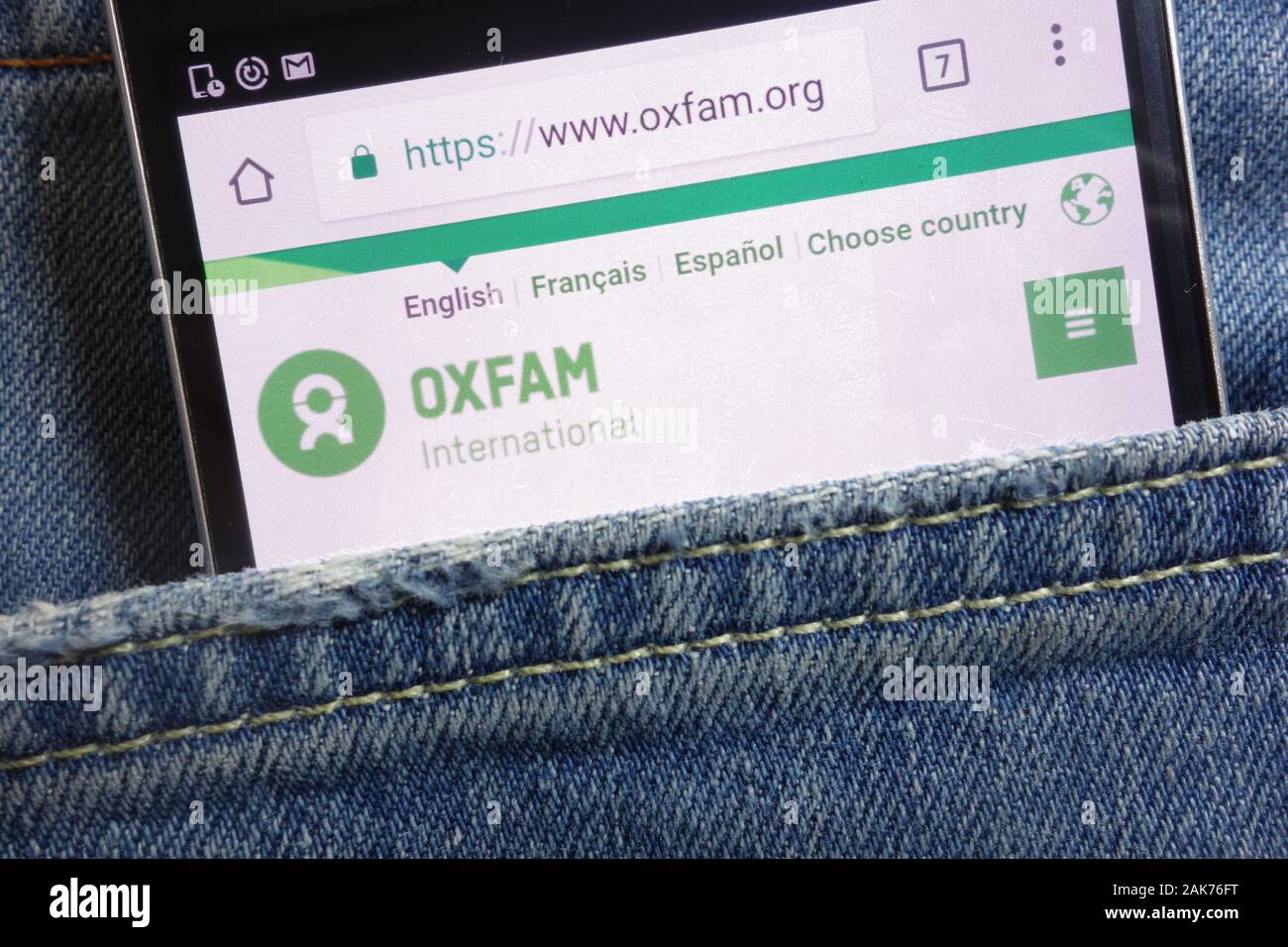 Oxfam website displayed on smartphone hidden in jeans pocket Stock ...