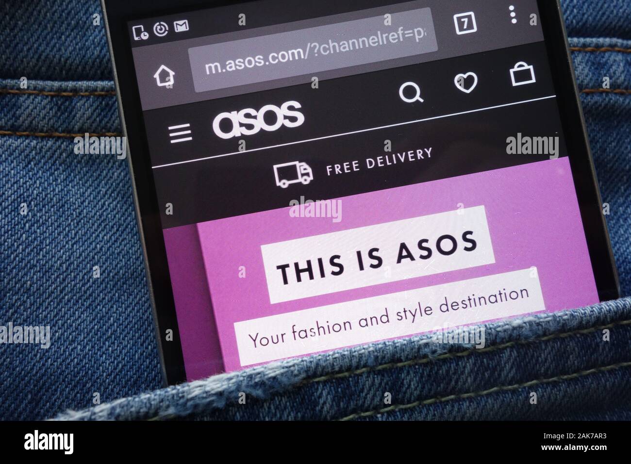 ASOS website displayed on smartphone hidden in jeans pocket Stock Photo ...