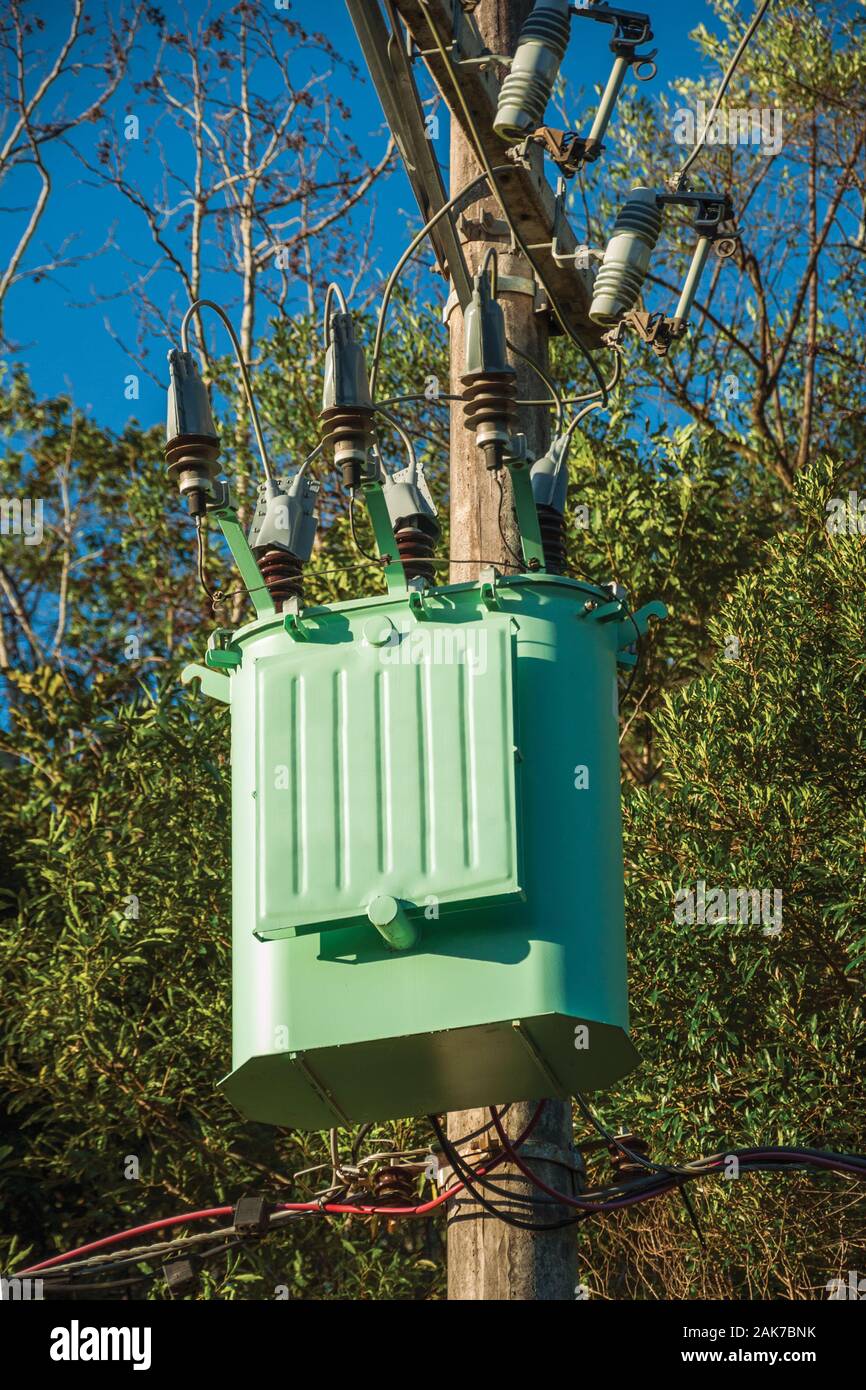 High-voltage power pole transformer with electrical wiring in front of ...