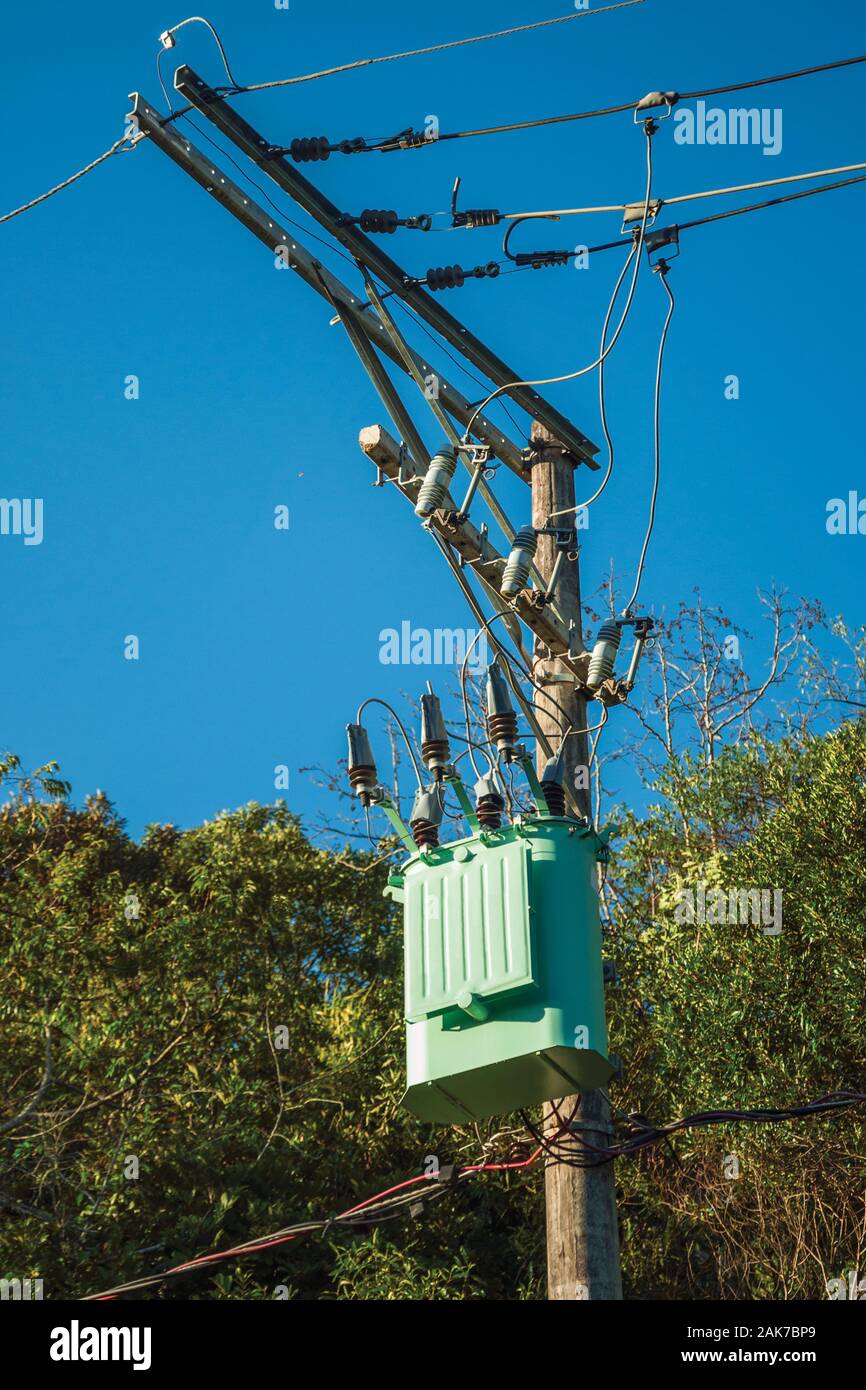 High-voltage power pole transformer with electrical wiring in front of ...
