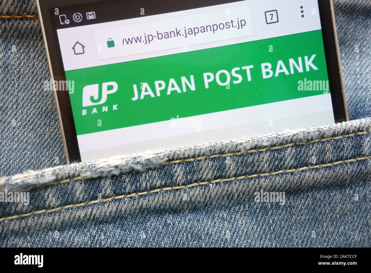 Japan Post Bank website displayed on smartphone hidden in jeans pocket ...