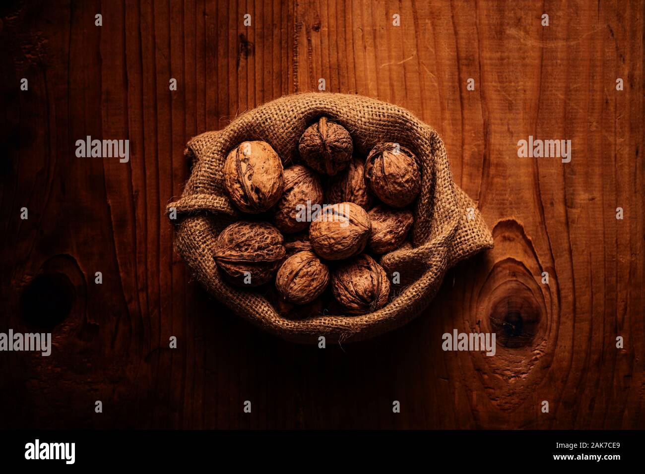 Walnut shell heap in eco friendly burlap sack, top view Stock Photo - Alamy