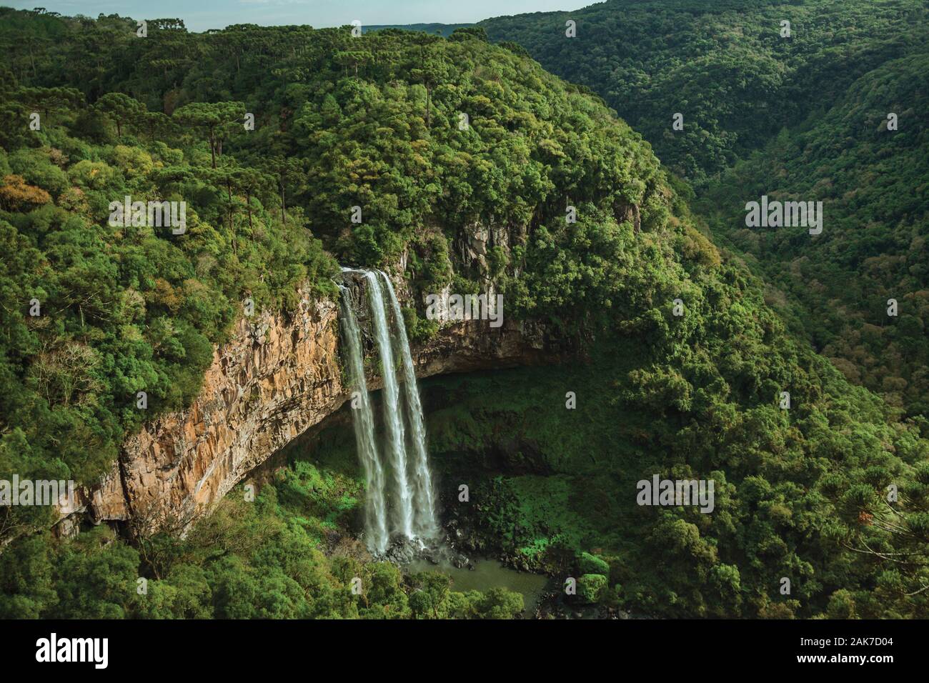 Caracol waterfall falling from rocky cliff in a forest from a park near ...