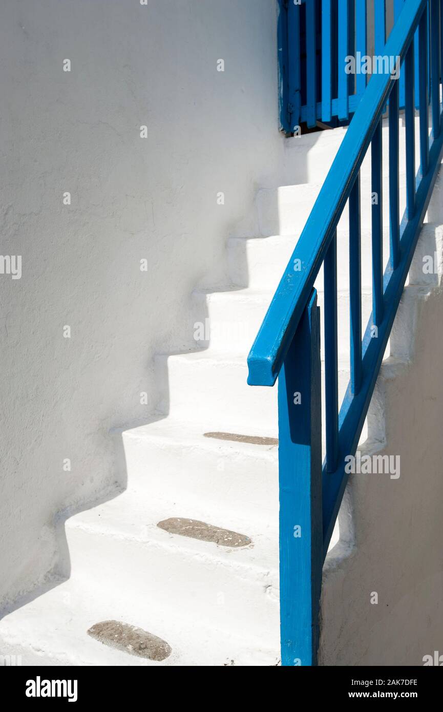Classic Mediterranean white stucco staircase leading to bright blue ...