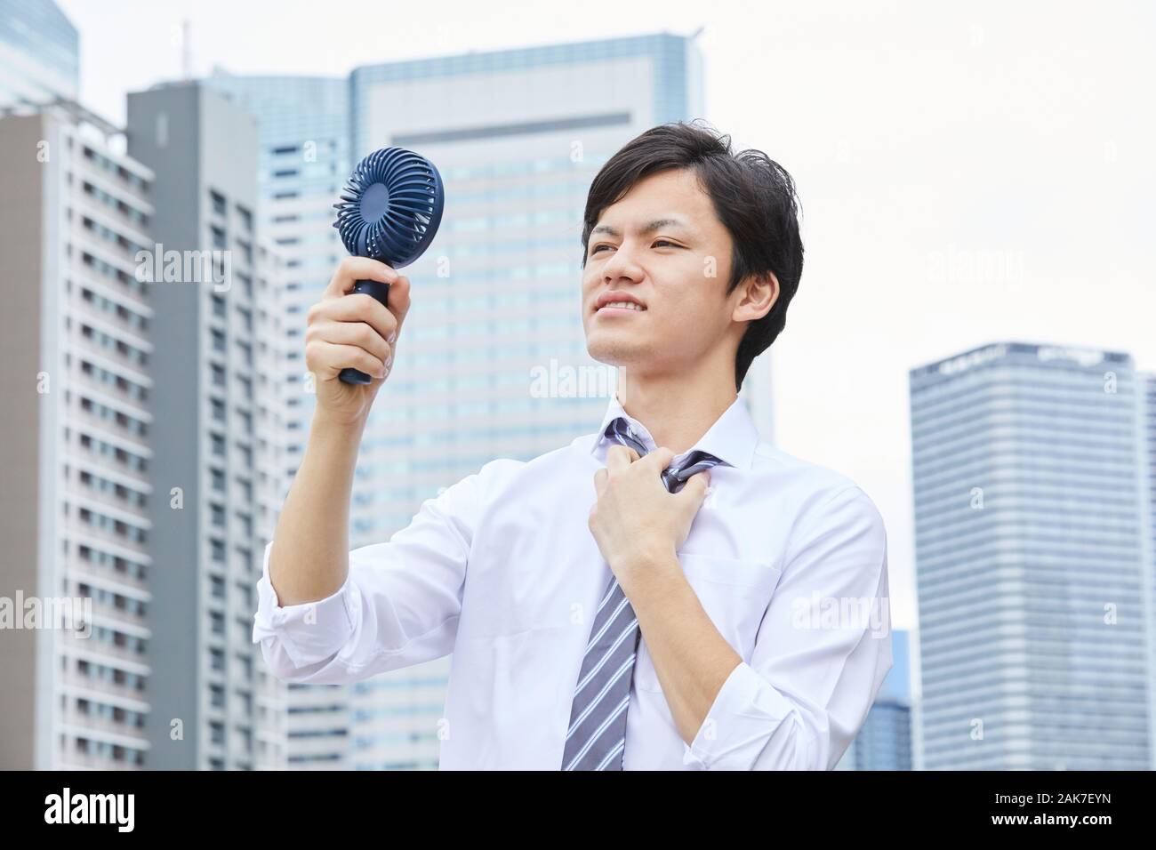 Japanese man with portable fan Stock Photo - Alamy