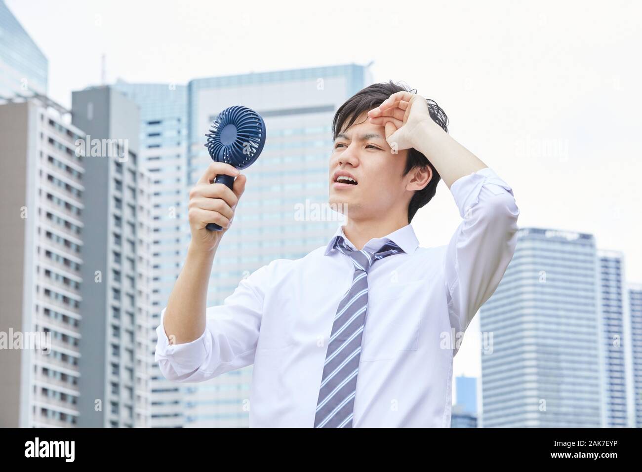 Japanese man with portable fan Stock Photo - Alamy
