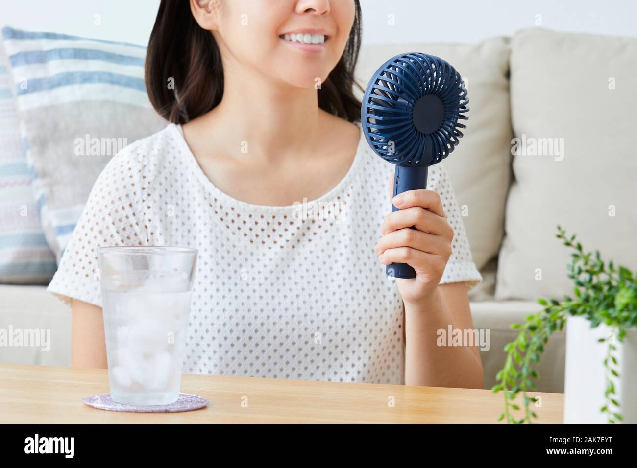 Woman holding portable fan hi-res stock photography and images - Alamy