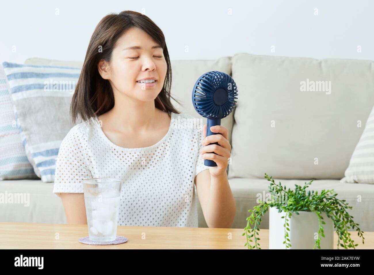 Japanese woman with portable fan Stock Photo - Alamy