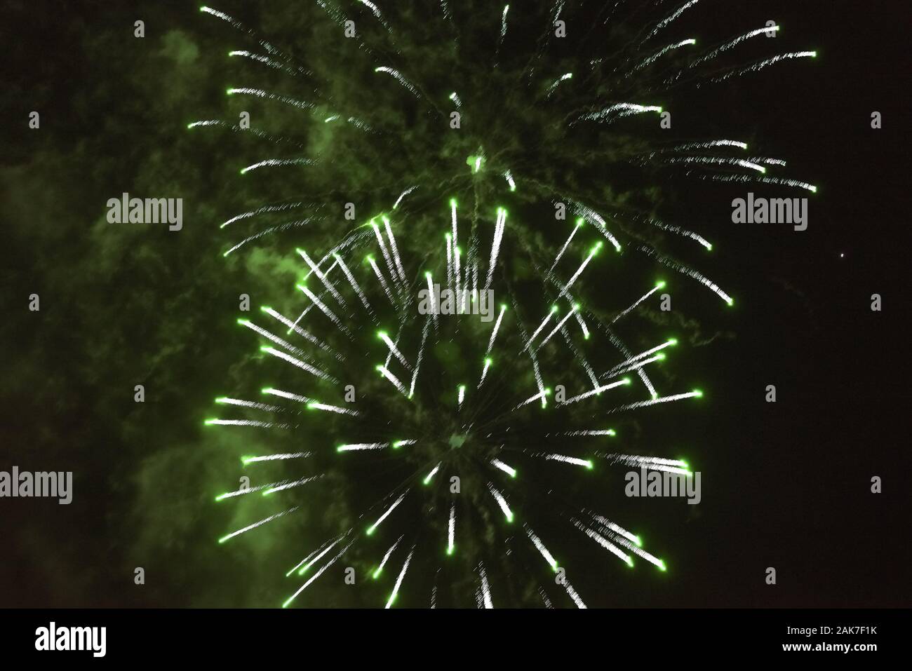 Fireworks, green on a dark sky background Stock Photo - Alamy