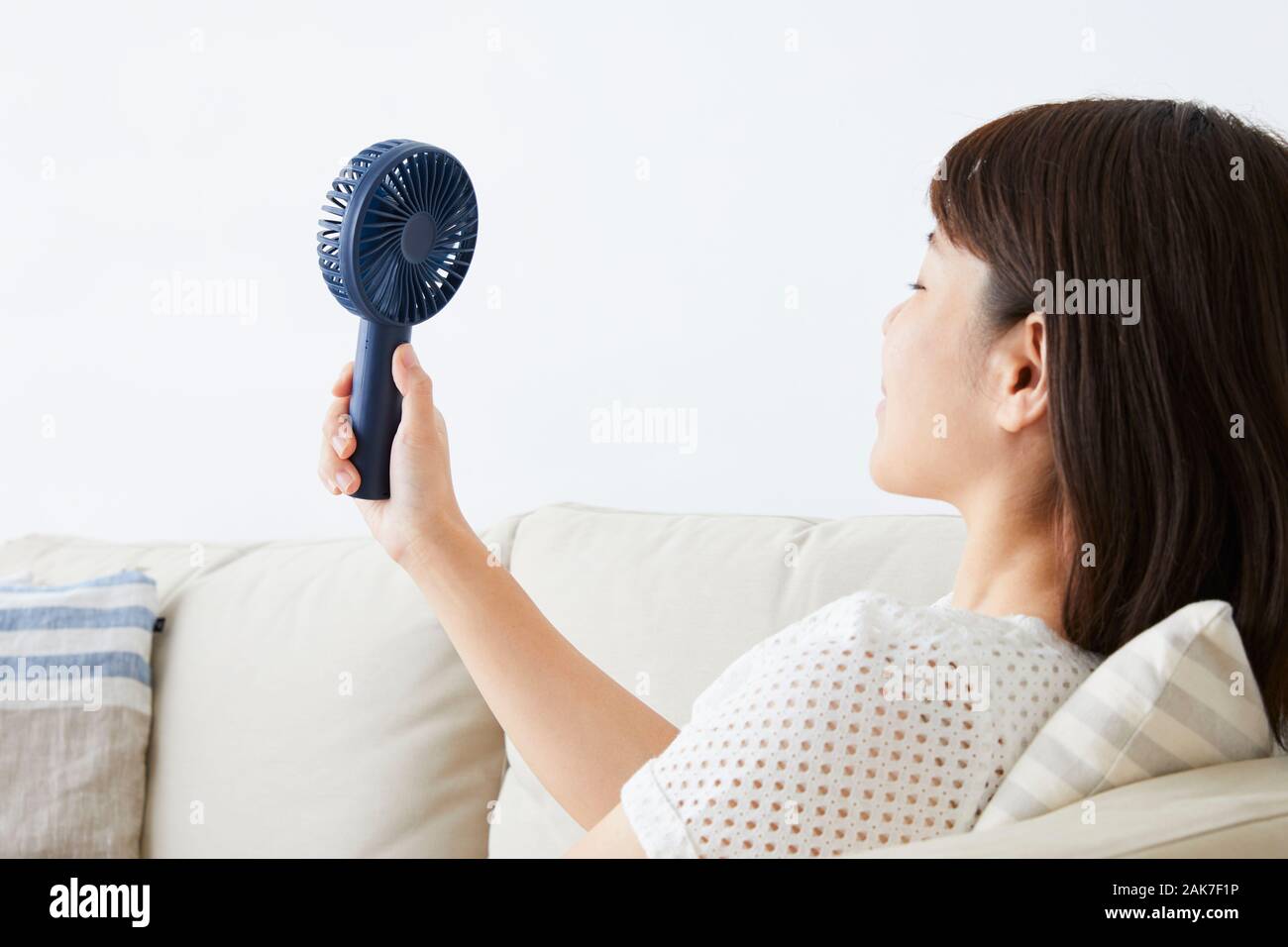Japanese woman with portable fan Stock Photo - Alamy