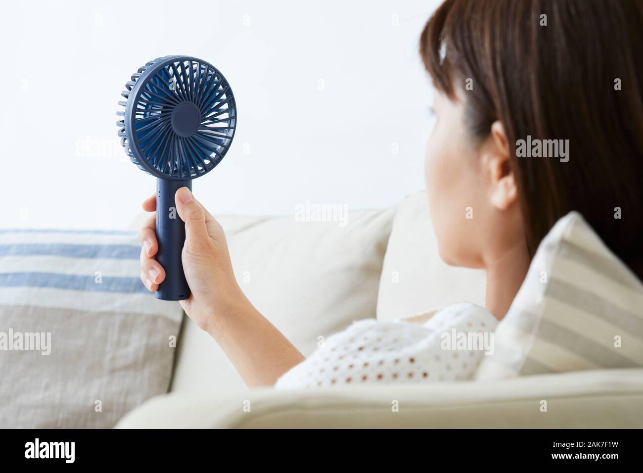 Woman holding portable fan hi-res stock photography and images - Alamy