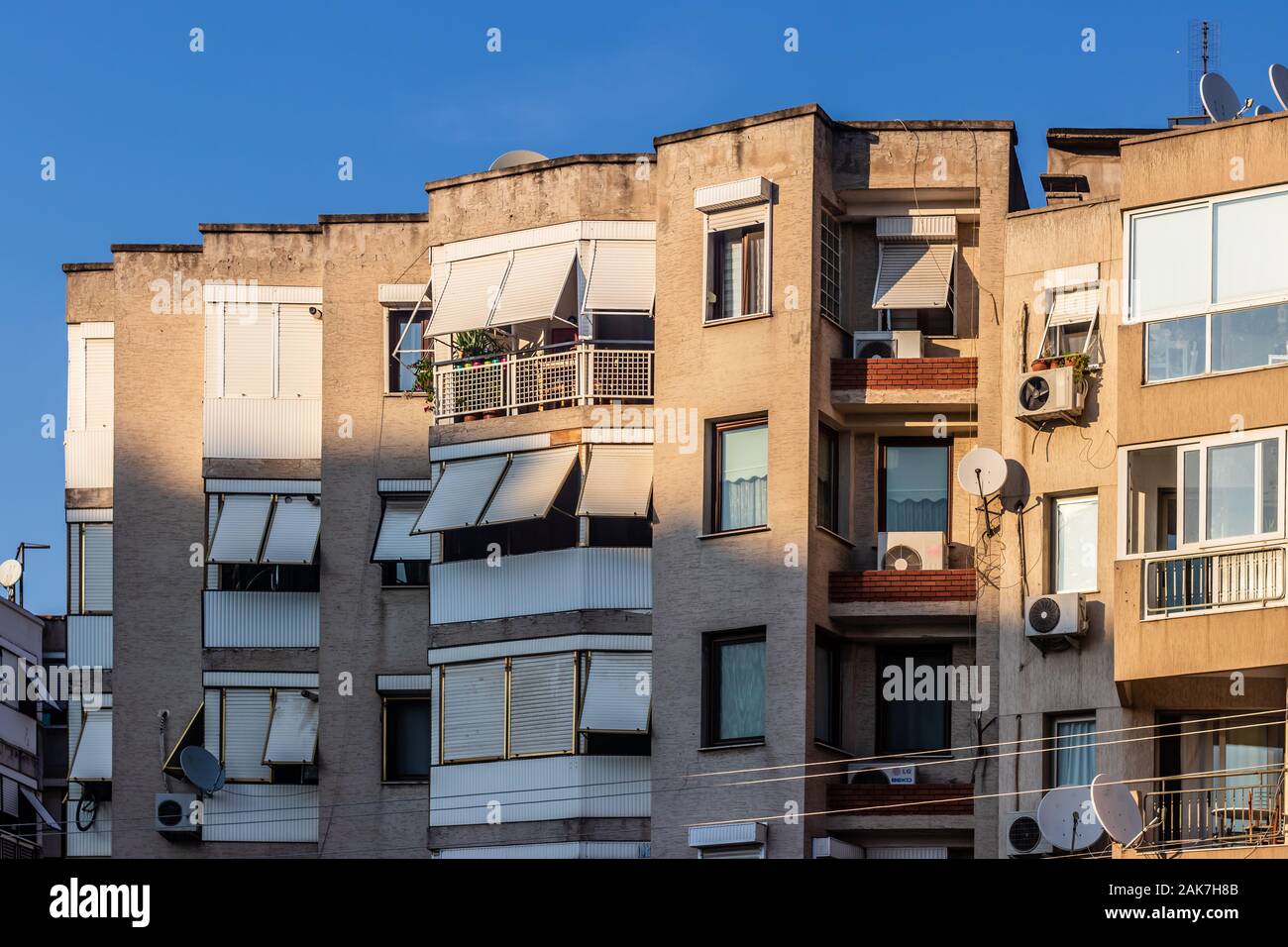 a front view shoot from an old apartments with sun light and shadow ...