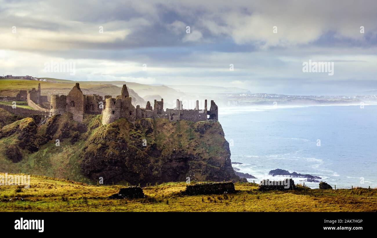 Ruined medieval Dunluce Castle on the cliff in Bushmills, Northern ...