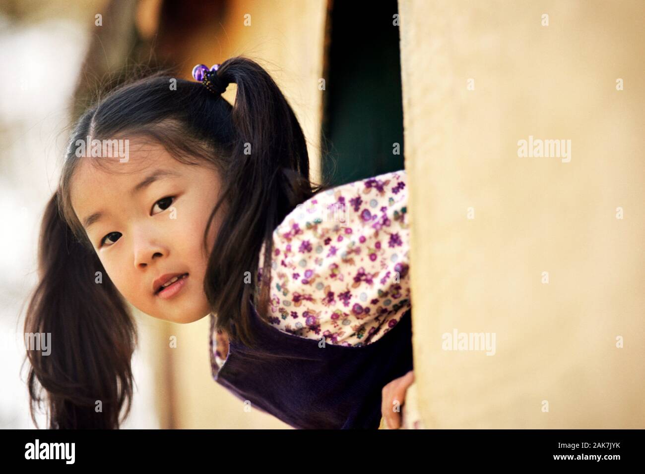 Little girl leaning out of playhouse window Stock Photo - Alamy