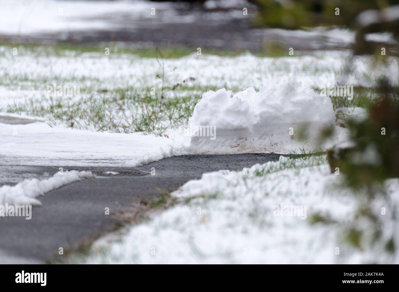 Pile of snow after winter service on a path Stock Photo - Alamy