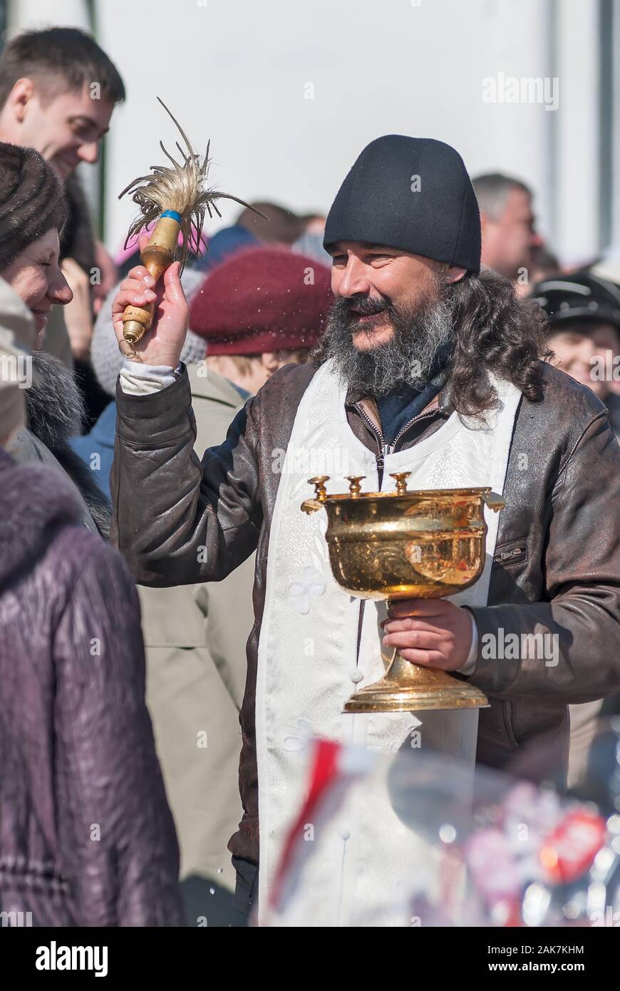 Priest blessing people with holy water. Tyumen Stock Photo - Alamy