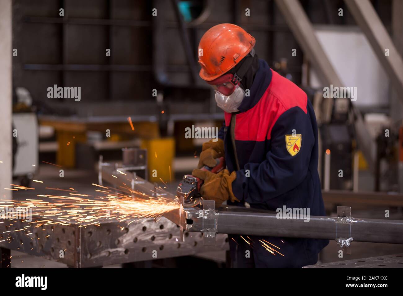 Industrial worker cutting metal with many sparks Stock Photo - Alamy