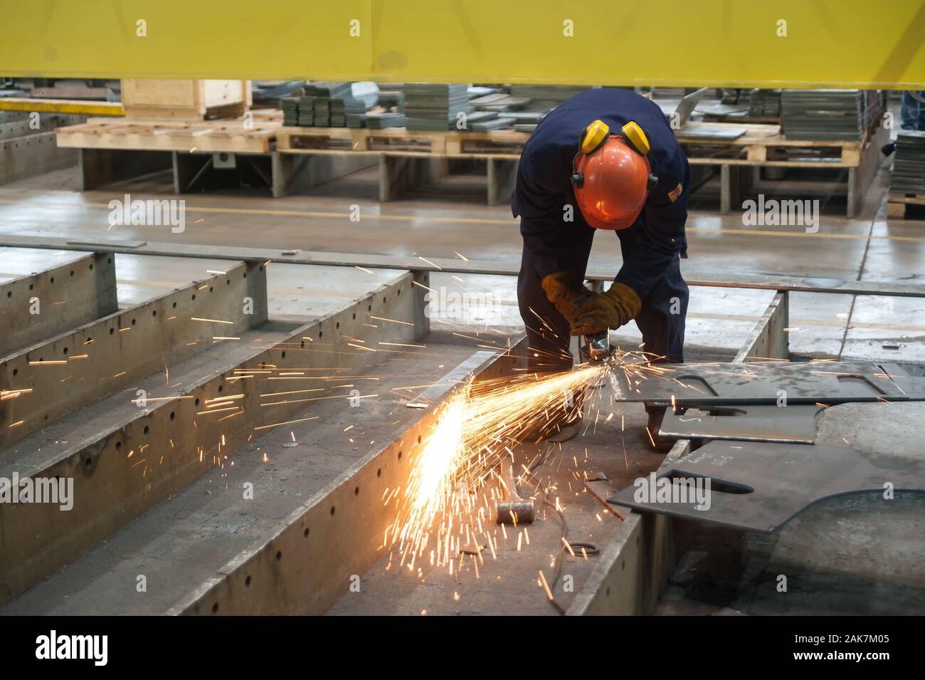 Industrial worker cutting metal with many sparks Stock Photo - Alamy