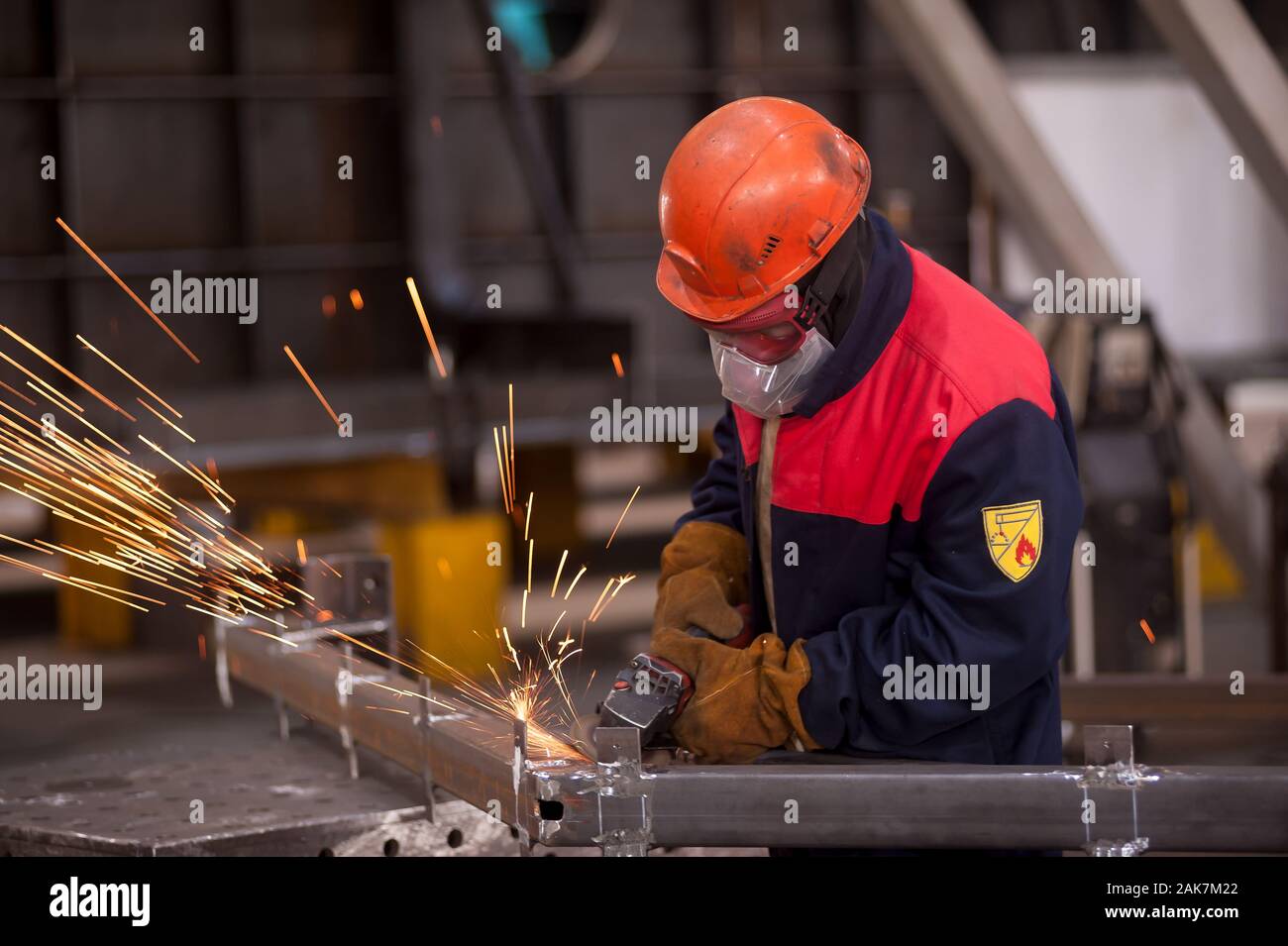 Industrial worker cutting metal with many sparks Stock Photo - Alamy
