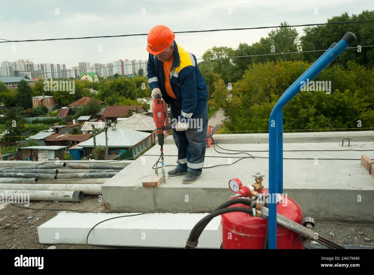 Worker drilling concrete at construction site Stock Photo - Alamy
